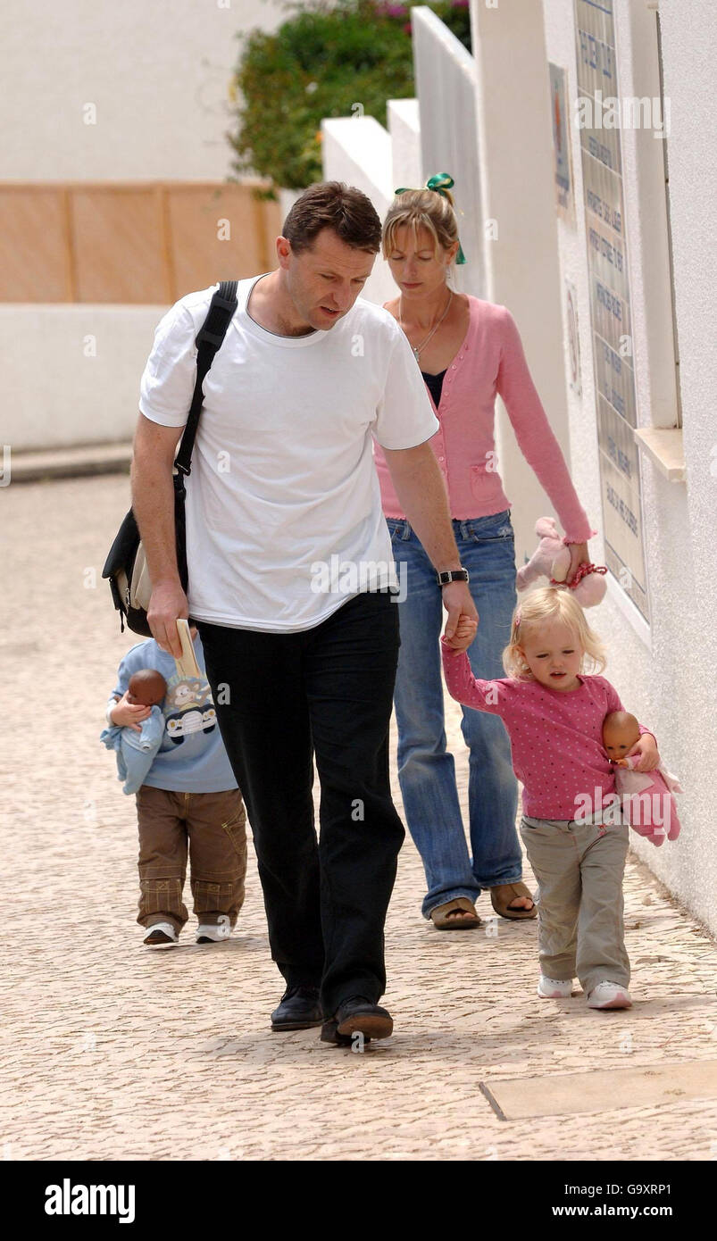 Full length couple parents holding hands child children toy walking hi ...