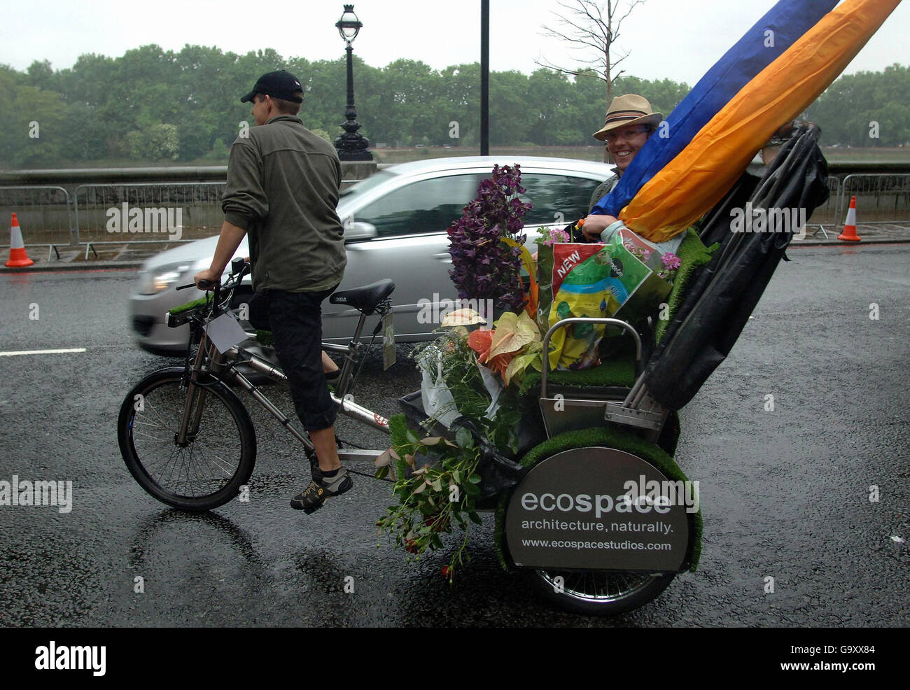 A gardening enthusiast carries plants home on a rickshaw after the last ...