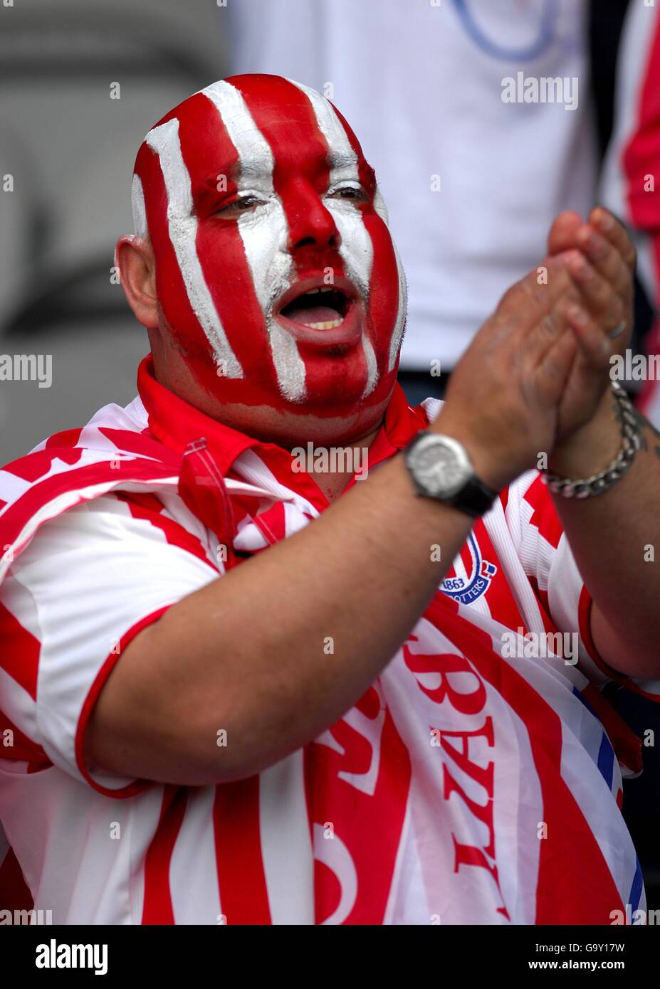 A Stoke City fan with his face painted in the team colours Stock Photo ...