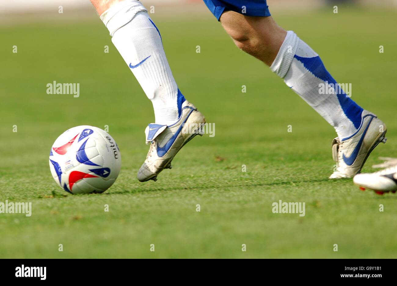Two legs and football boots hi-res stock photography and images - Alamy