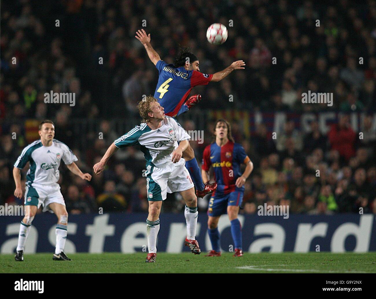 Barcelona's Rafael Marquez and Liverpool's Dirk Kuyt battle for the ...