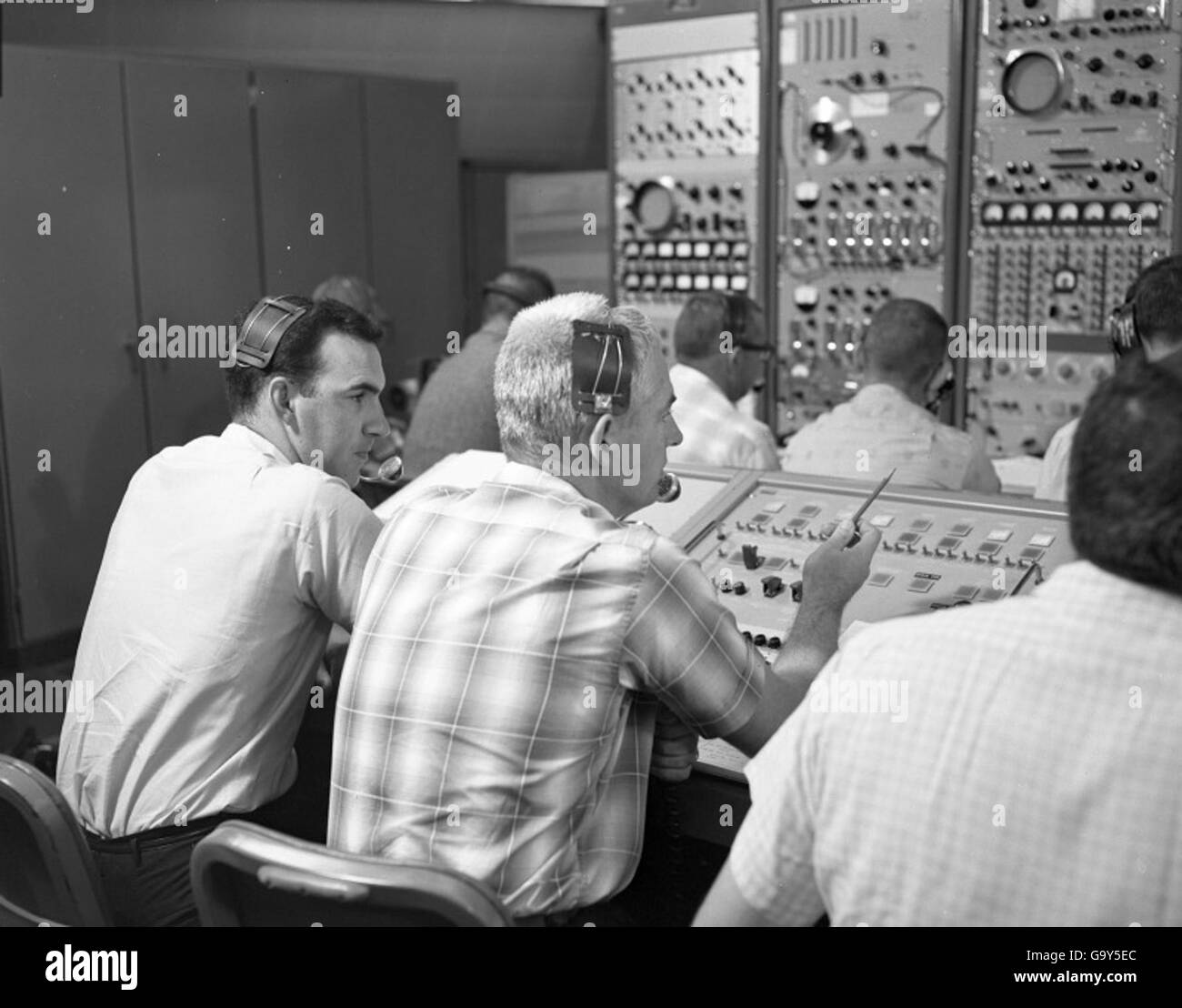 An Atlas missile on the launch pad, with military personnel performing ...