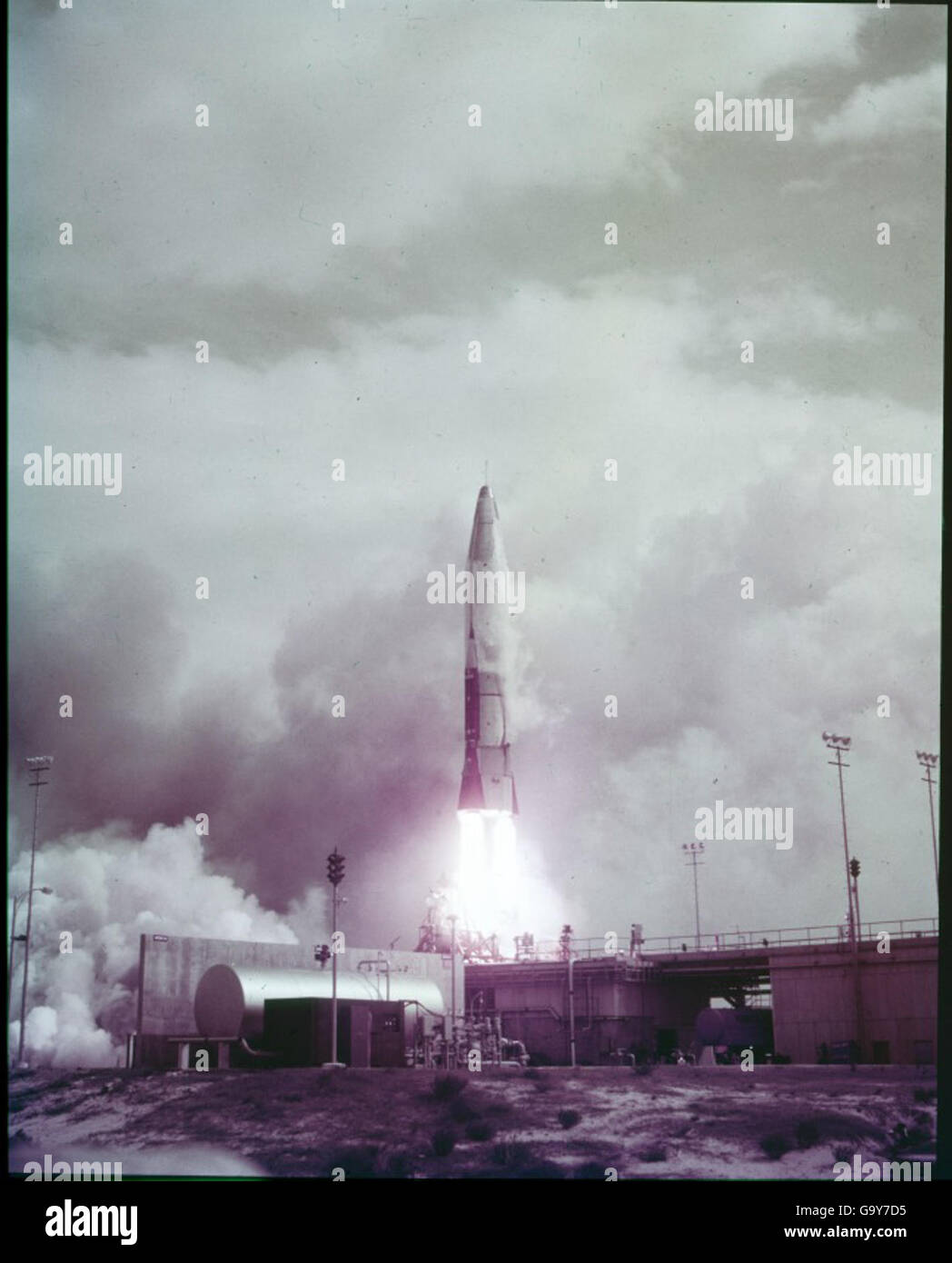 An Atlas missile stands on the launch pad, undergoing final ...