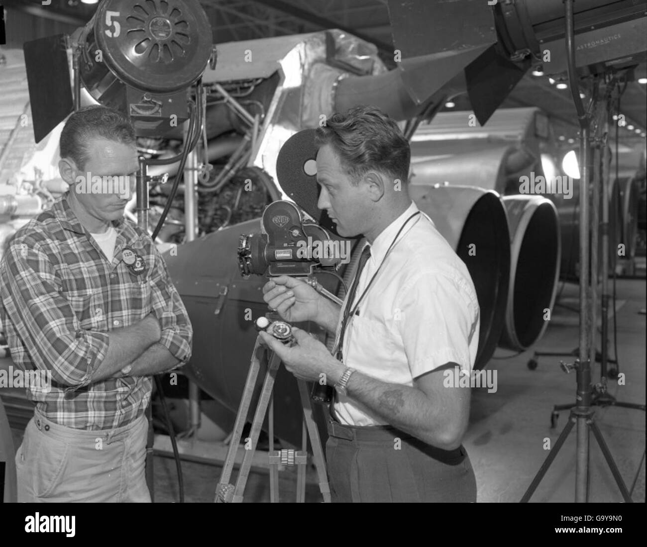 The Atlas missile undergoes a crucial pre-launch inspection. Engineers ...