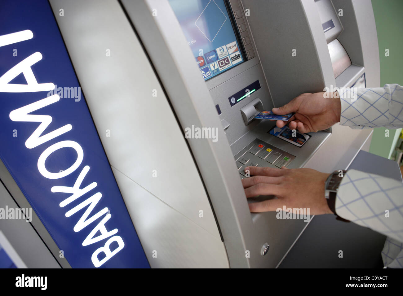 Withdrawing money from an ATM Stock Photo - Alamy