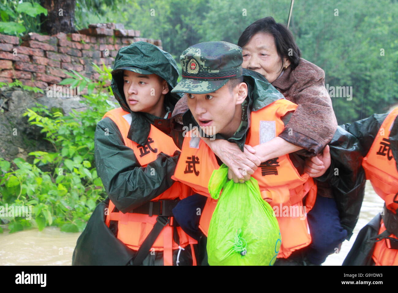 Anqing, China's Anhui Province. 2nd July, 2016. Rescuers evacuate a ...