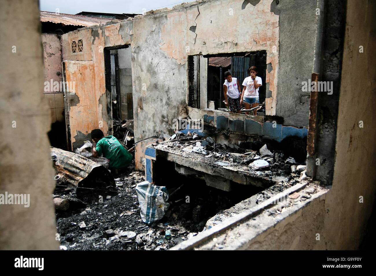 Philippines. 2nd July, 2016. Fire victims survey their burned down ...