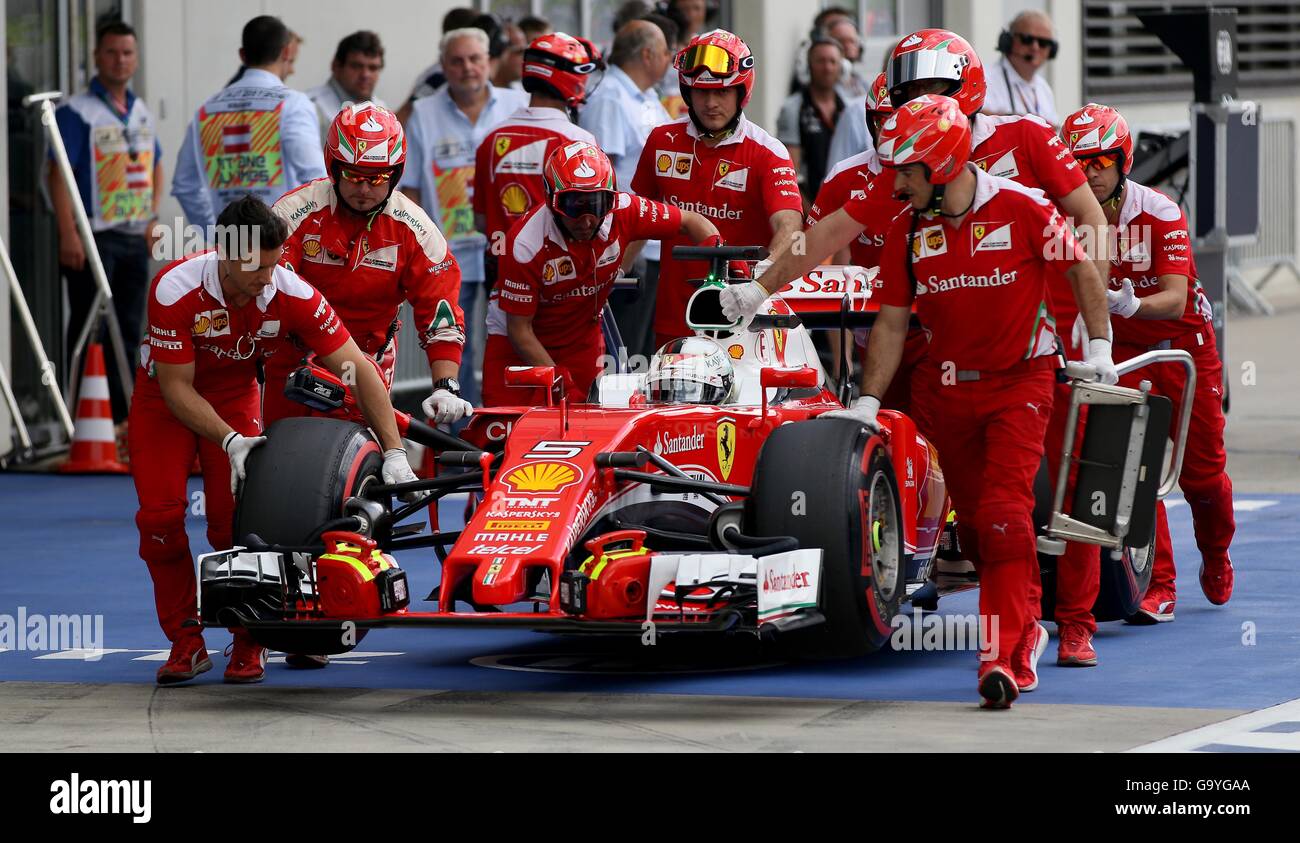Ferrari driver Sebastian Vettel of Germany gets pushed back into his ...