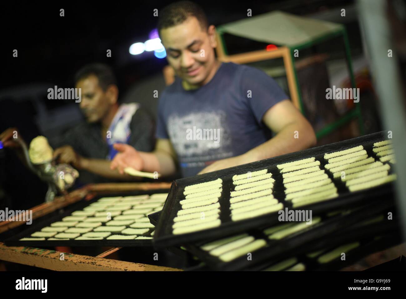 Mansoura, Eid al-Fitr in Mansoura. 3rd July, 2016. An Egyptian baker ...