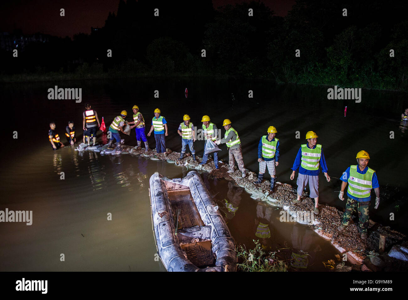 Wuhan, China's Hubei Province. 4th July, 2016. Rescuers work to build a ...