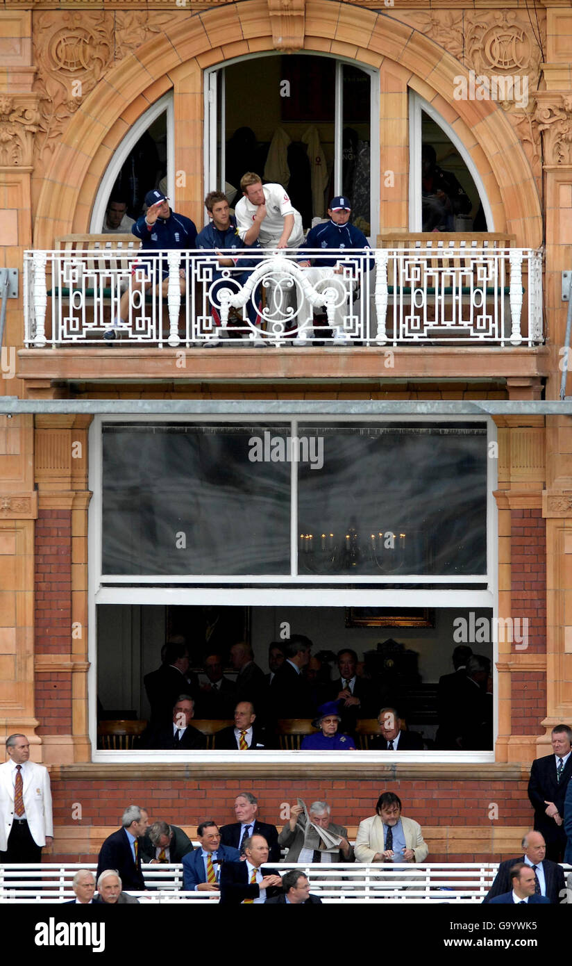 The Queen (below) as the England cricket team members look on during ...