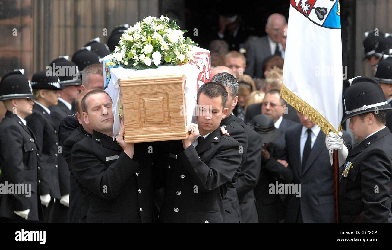 The coffin of policeman Ricky Gray is carried by West Mercia Police Force colleagues from ...
