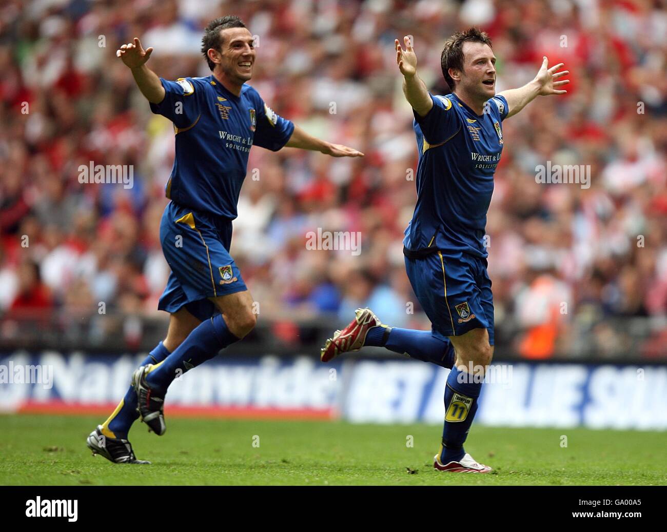 Morecambe's Garry Thompson (right) celebrates scoring the second goal ...
