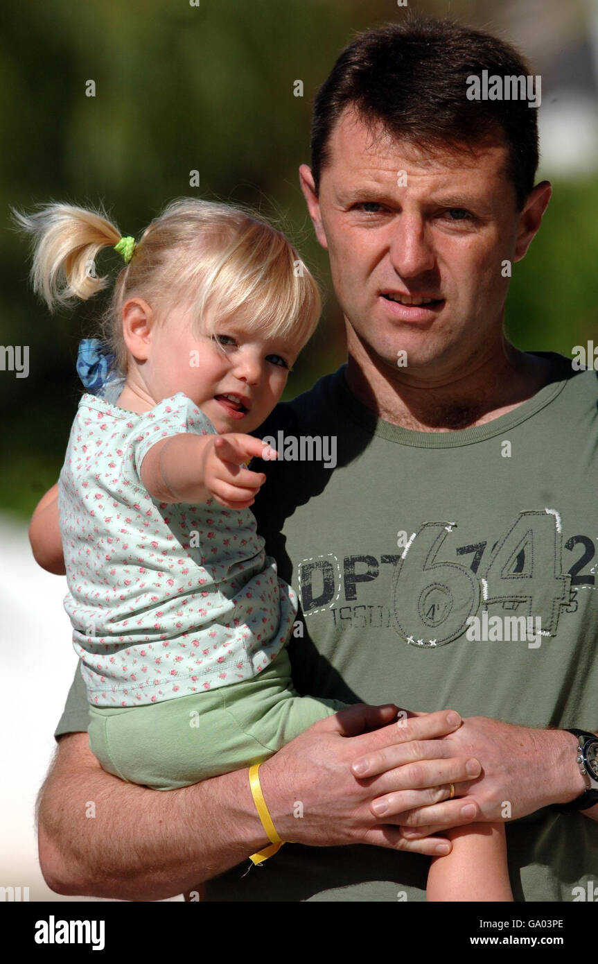 Gerry McCann carries daughter Amelie as he and wife Kate take their ...