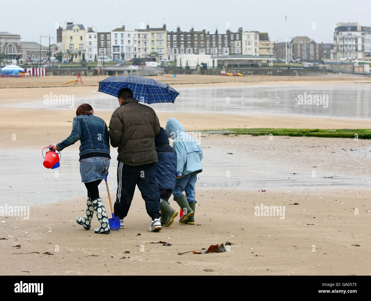 Family beach umbrella bad weather hi-res stock photography and images ...
