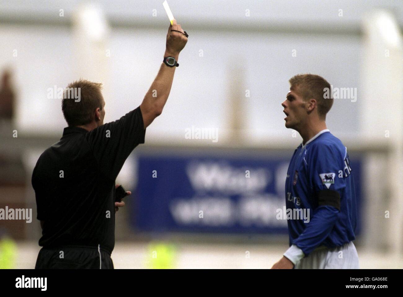 (L-R) Referee Graham Poll cautions Ipswich Town's Hermann Hreidarsson ...