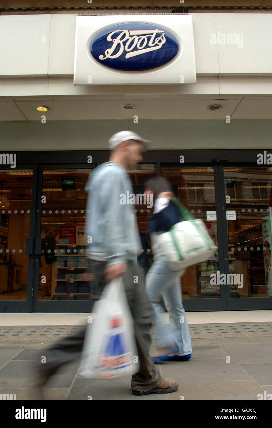 View people walking past exterior high street chemist boots hi-res ...