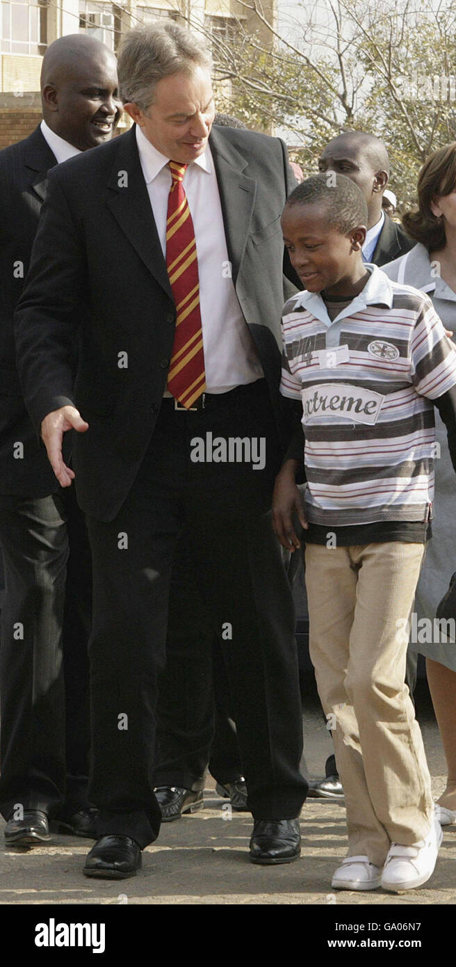 British Prime Minister Tony Blair walks with HIV patient 14-year-old ...