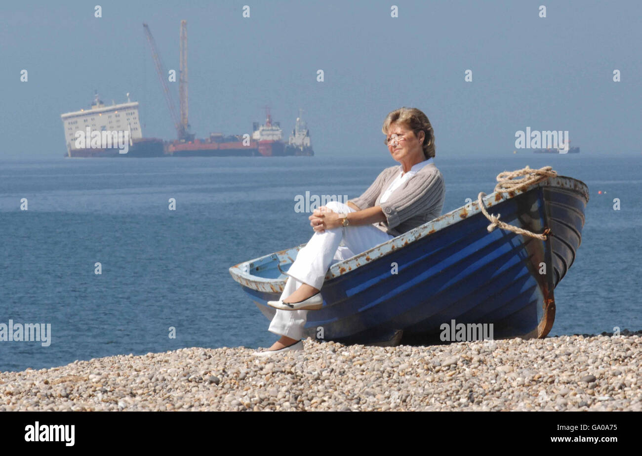 Anita Bokdal on Branscombe beach in Devon with the grounded container ...
