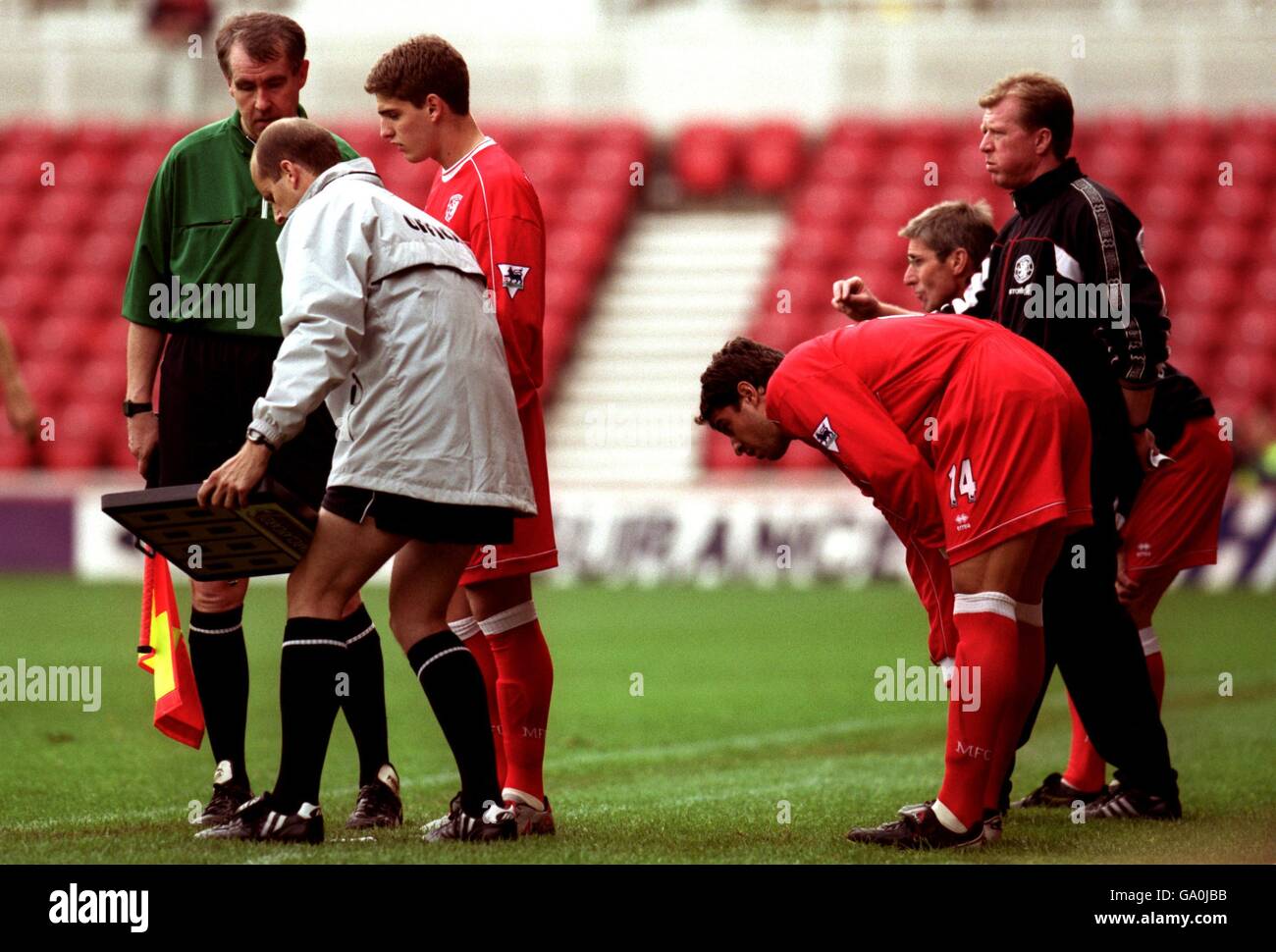 Fourth official Mike Pike (second l) programmes the electronic board as ...