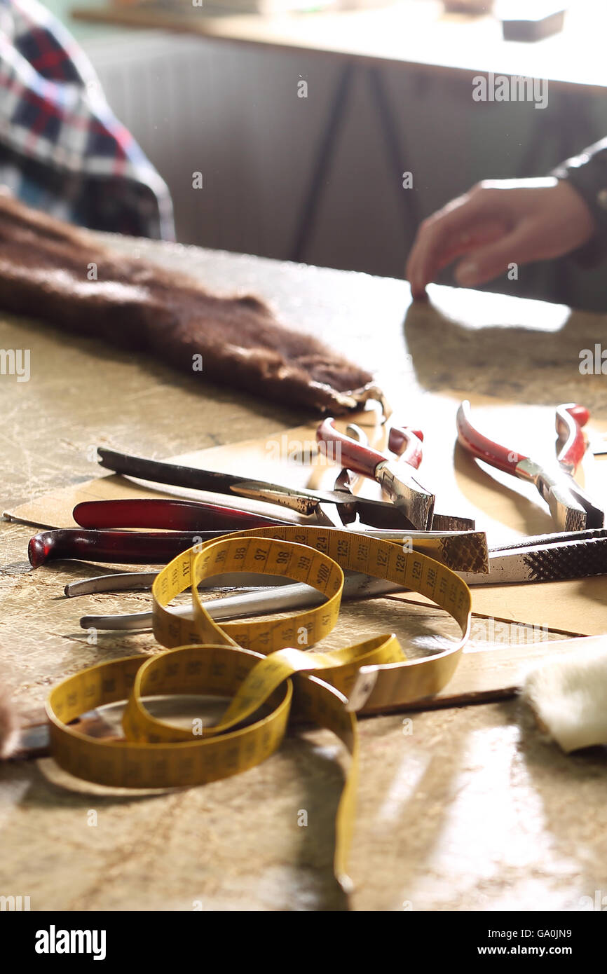 Workshop furrier, utensils, tools and pieces of natural fur Stock Photo ...