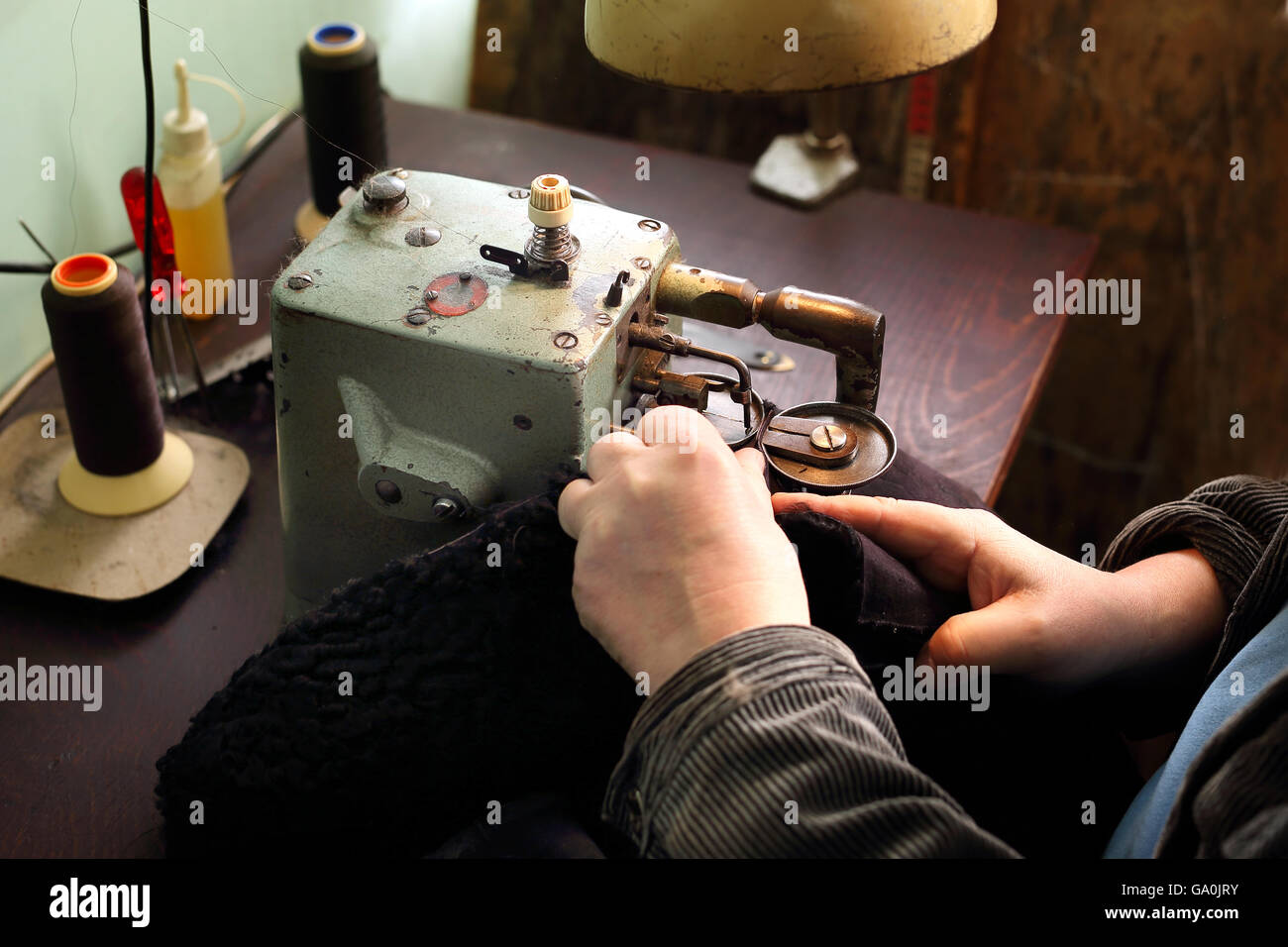Furrier at the factory in the neck fur coat Stock Photo - Alamy
