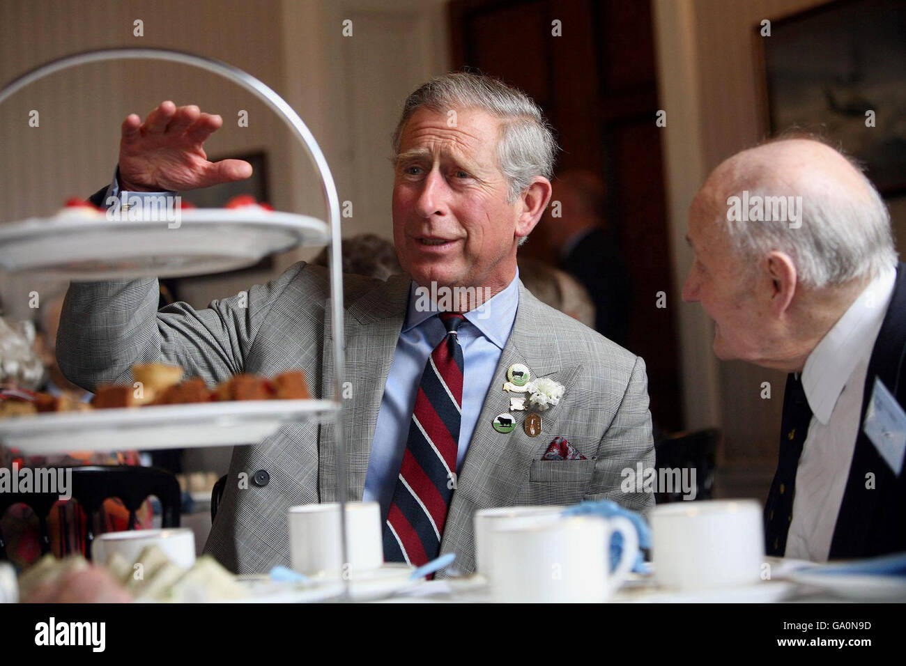 The Prince of Wales (left), gestures as he sits with Squadron Leader ...