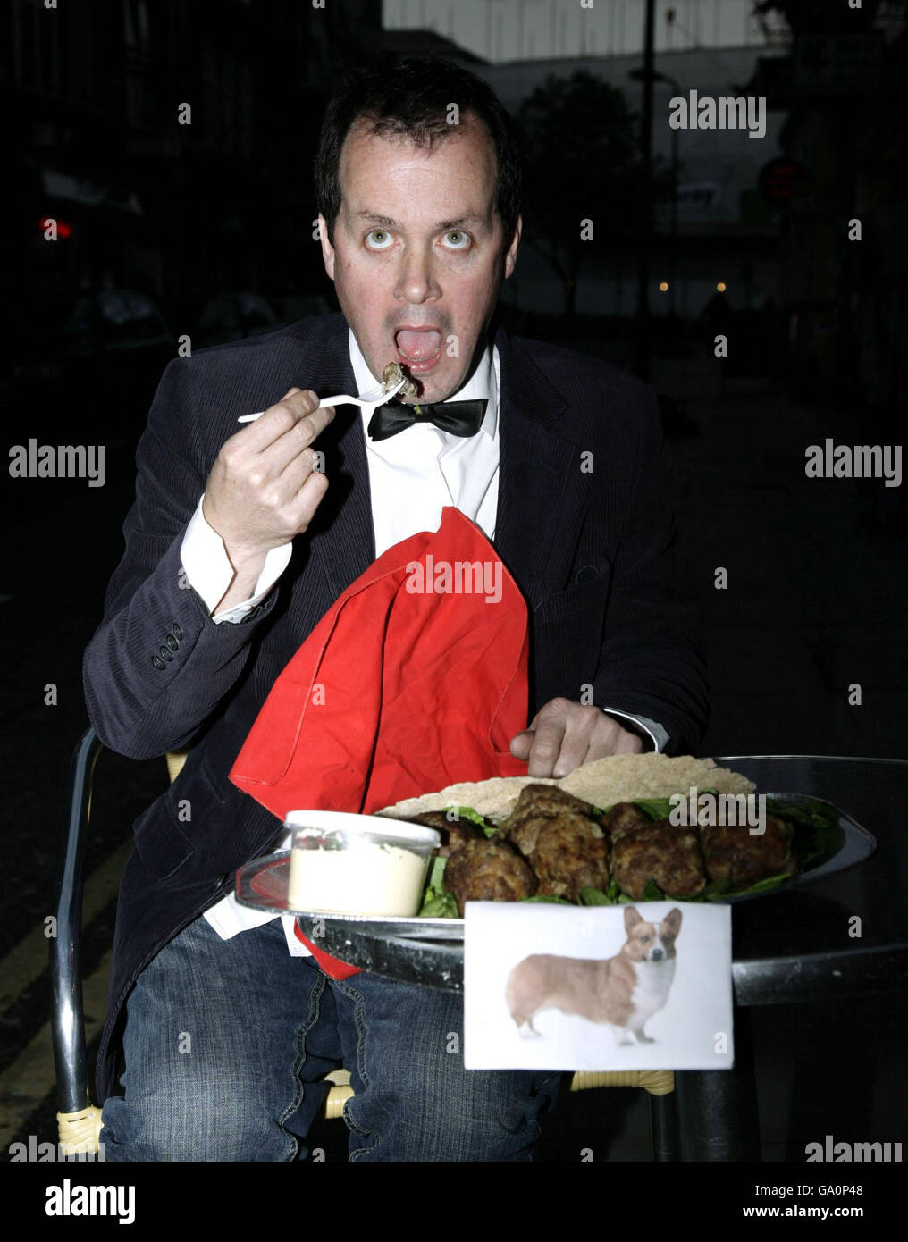 Artist and animal rights activist Mark McGowan eats a piece of Corgi ...