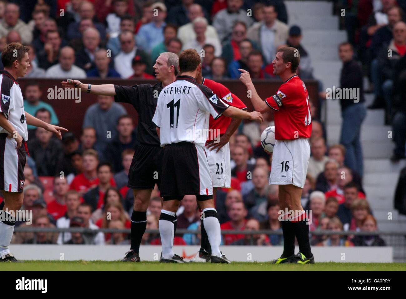 Manchester United's Roy Keane (r) has a lot to say as referee Neale ...