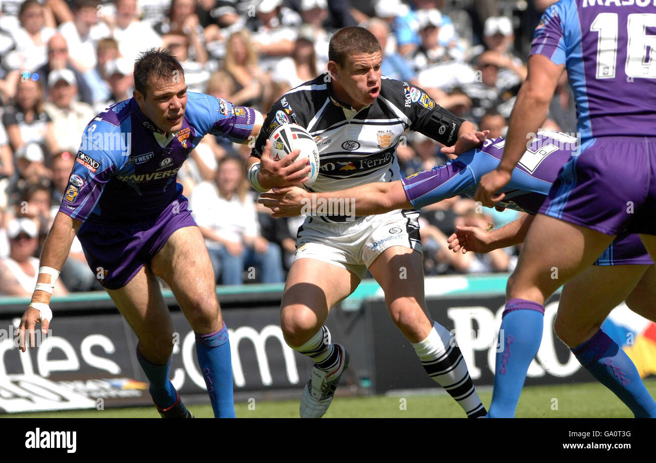 Hull FC's Lee Radford (centre) is tackled by Huddersfield's Steve ...