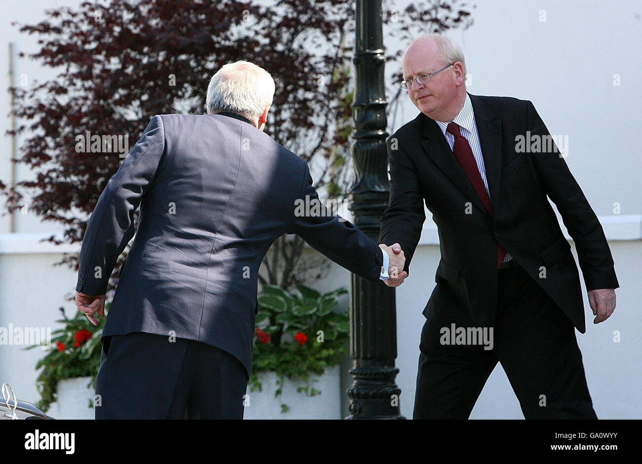 Taoiseach Bertie Ahern shakes hands with Tanaiste Michael McDowell ...