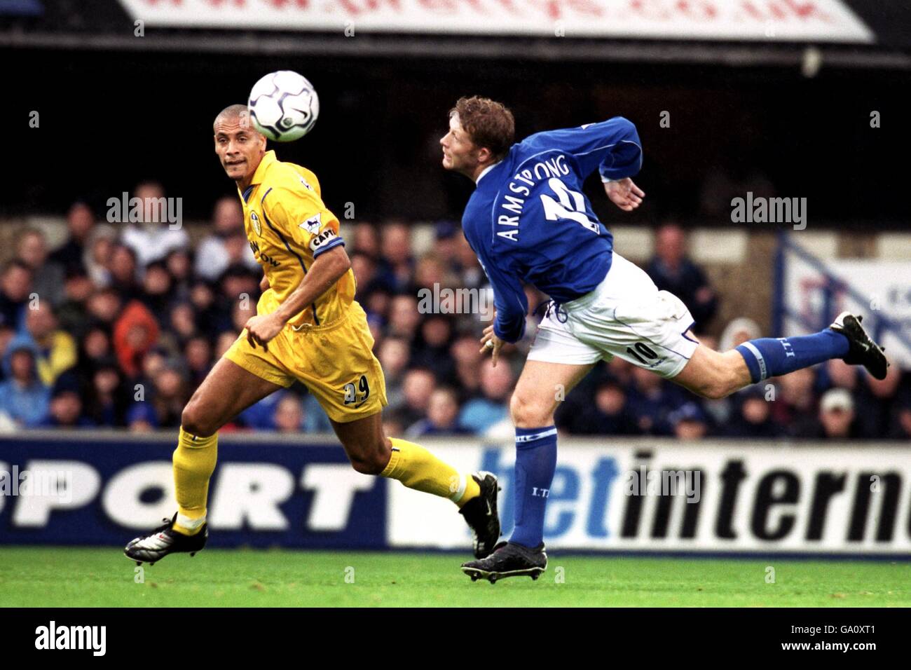 Ipswich Town's Alan Armstrong (r) stretches for the ball as Leeds ...