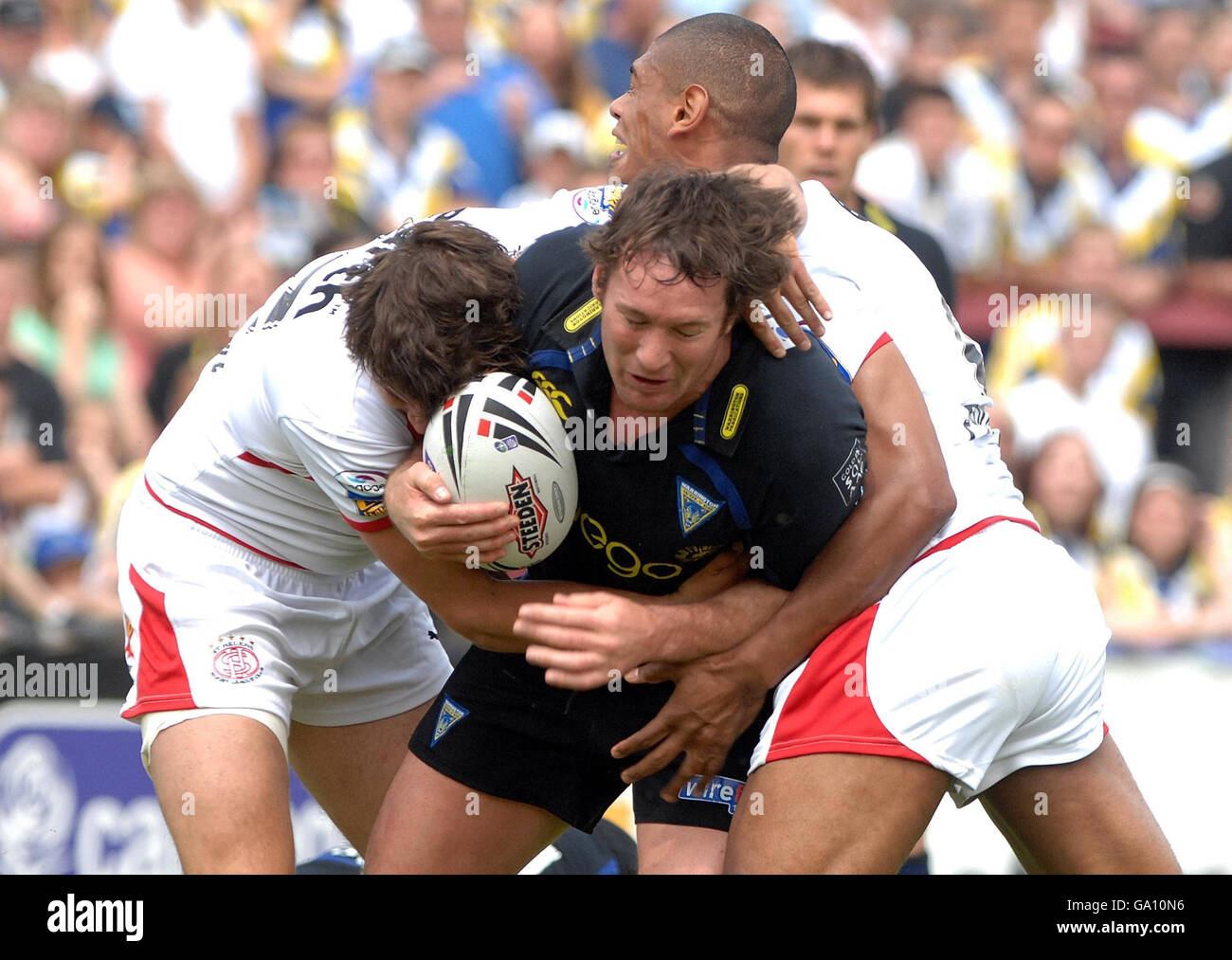 Warrington's Mike Wainwright tackled by St Helen's Jon Wilkin and Leon ...