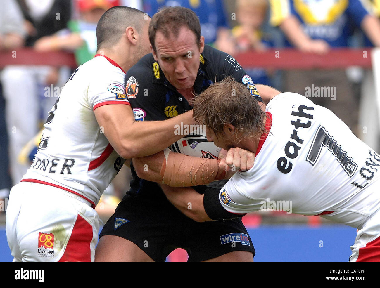 Warrington's Paul Johnson is tackled by St Helen's Ade Gardner and Sean ...