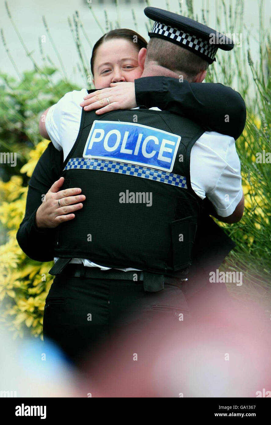 Mary Henry, the widow of murdered PC Jonathan Henry, is comforted by a ...
