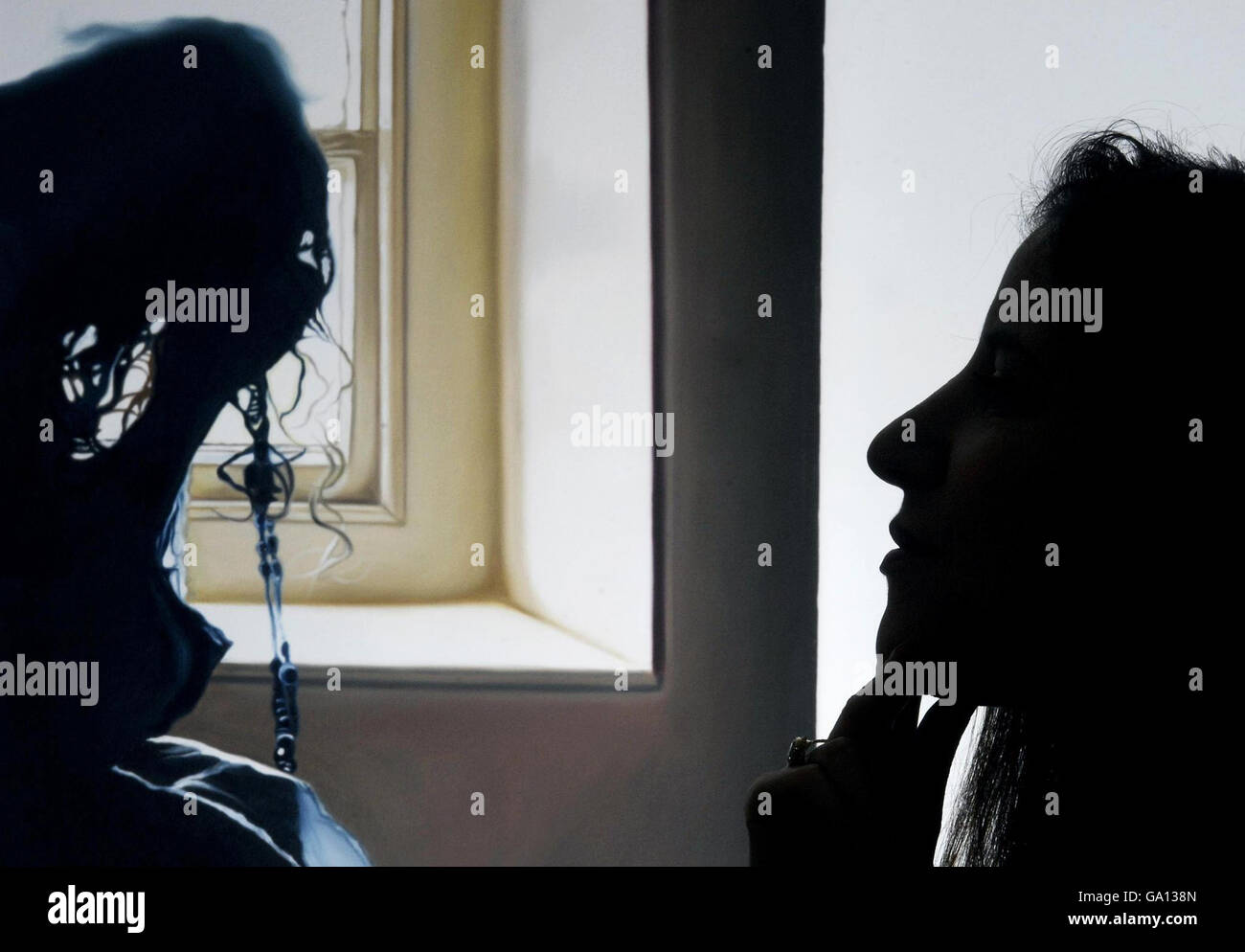 Randolph Gallery owner Margaret Bruce (right), looks at a piece of work ...