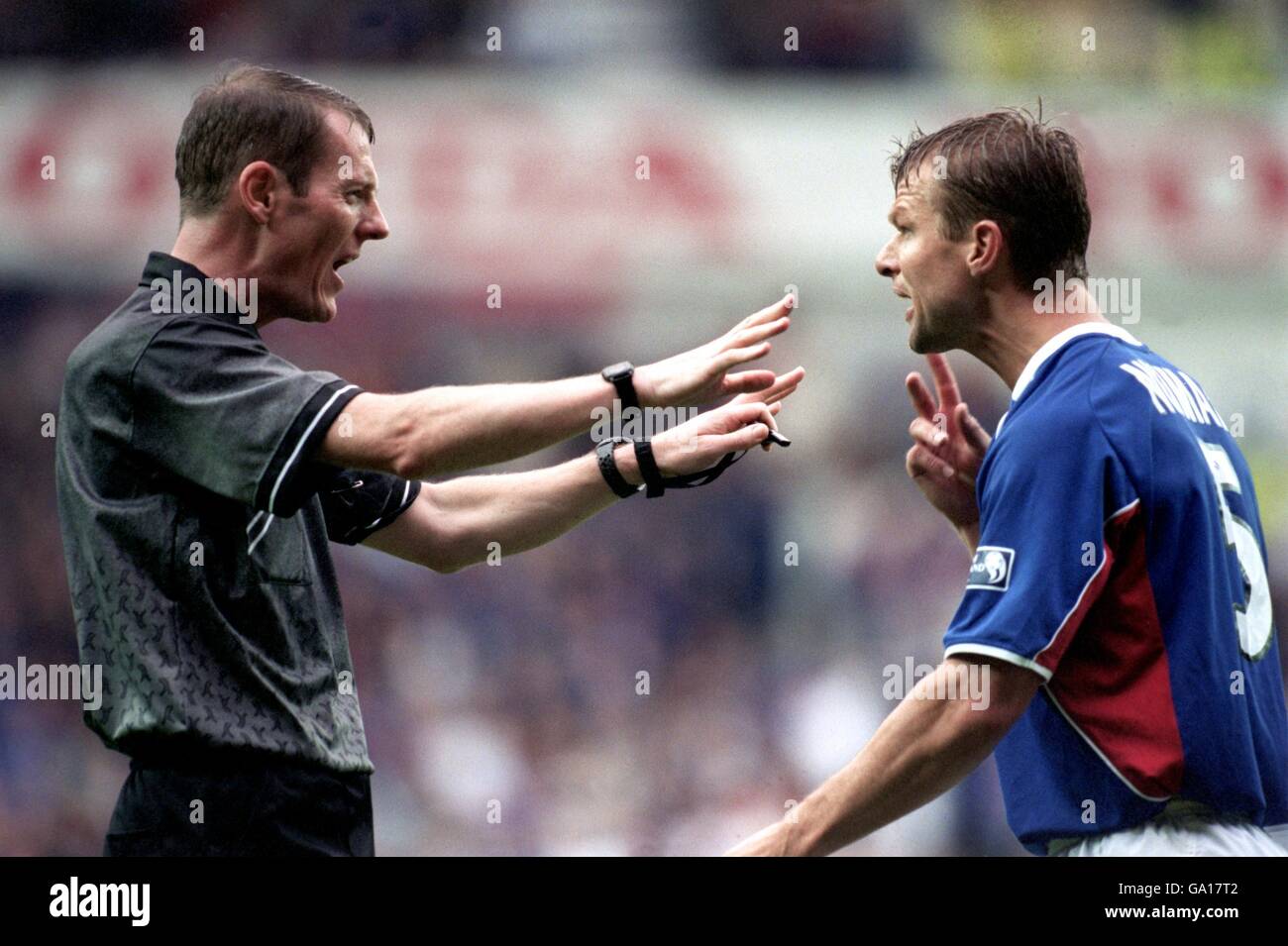 Referee Kenny Clark (l) waves away the protests of Rangers' Arthur ...