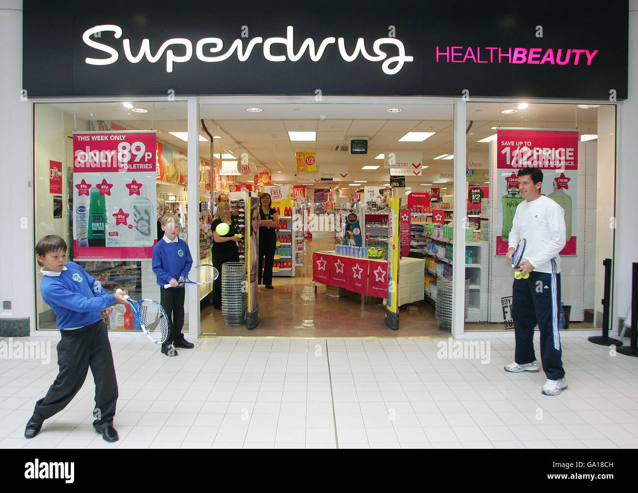 Tim Henman practices with Paul Wrona (left, age 9) and Jonah Ryan (age ...