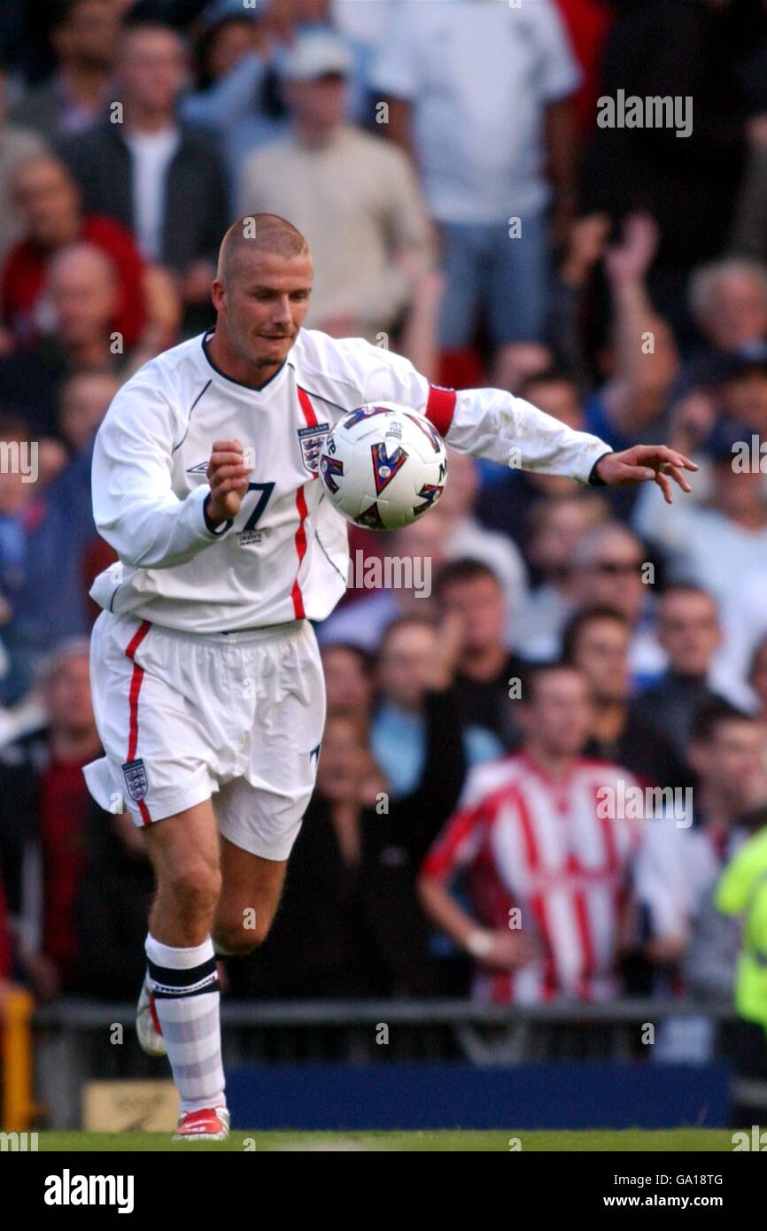England's David Beckham kicks the match ball into the crowd in ...