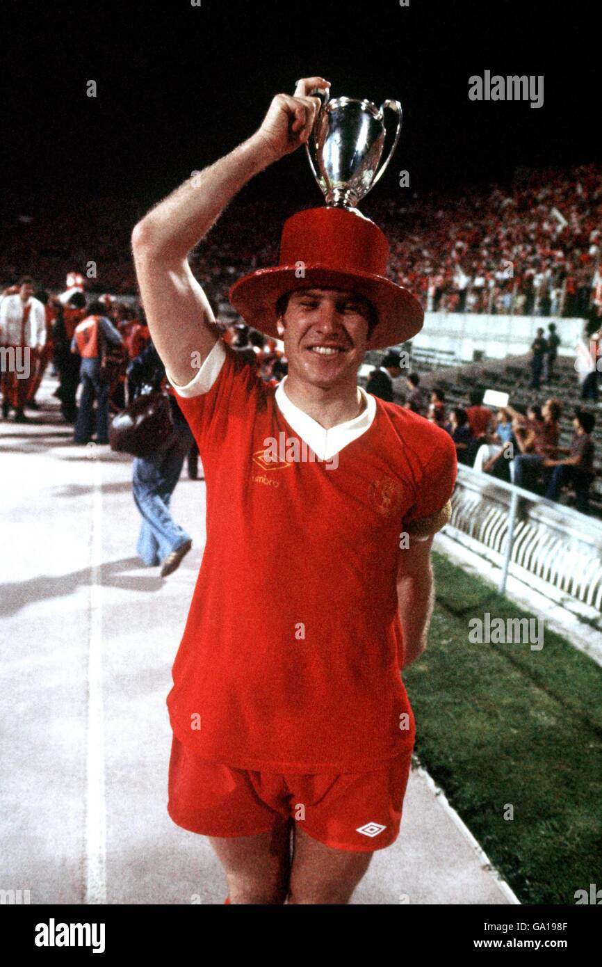 Liverpool captain Emlyn Hughes celebrates victory with his mini replica ...