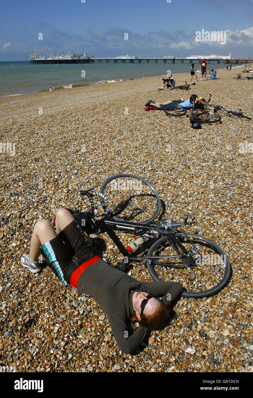 An exhausted competitor relaxes on the beach after arriving in Brighton ...