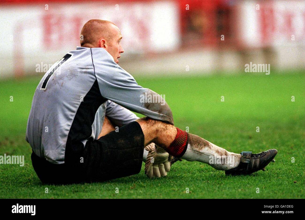 Alloa Athletic goalkeeper Derek Soutar sits on the turf at the full ...