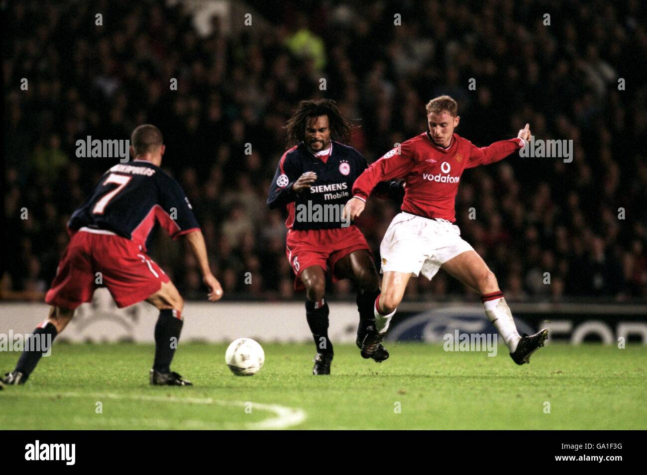 Manchester United's Nicky Butt is charged down by Olympiakos' Christian ...