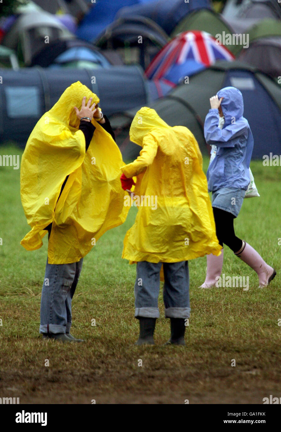 Festival goers prepare for muddy conditions after heavy showers are ...