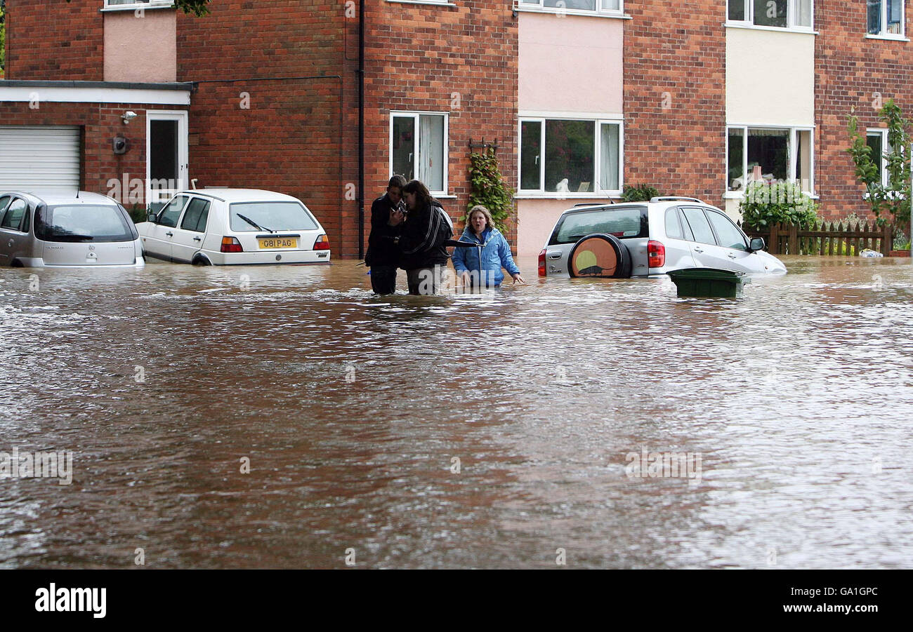 Residents wade through a water filled street in beverley hi-res stock ...