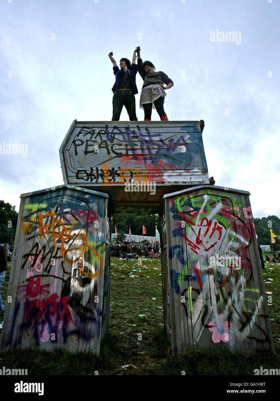 Festival goers stand on an installation by the artist Banksy to ...