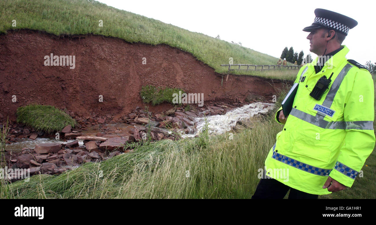 A police officer surveys the Ulley dam near Rotherham, South Yorkshire ...