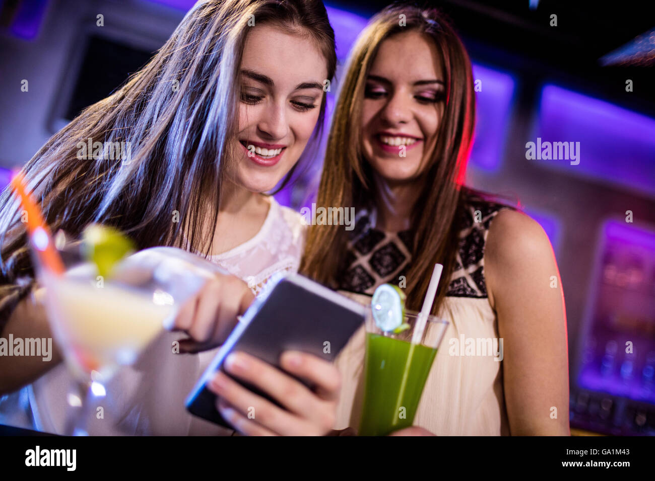 Beautiful women using mobile phone Stock Photo - Alamy