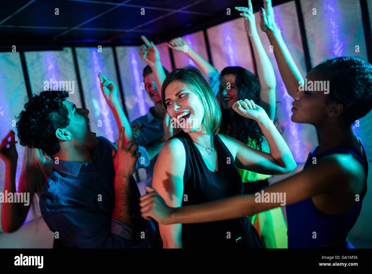 Group of smiling friends dancing on dance floor Stock Photo - Alamy
