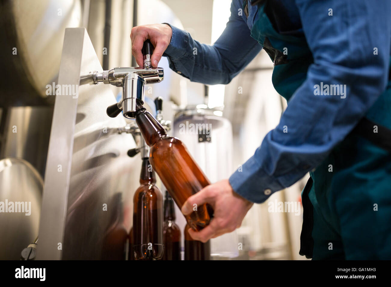 Brewer filling beer in bottle Stock Photo - Alamy